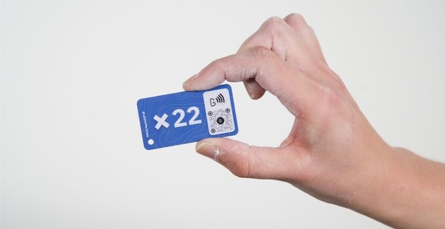 A hand holding a Griptonite route tag