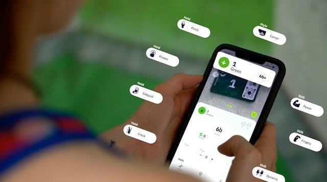 A hand holding a Griptonite route tag